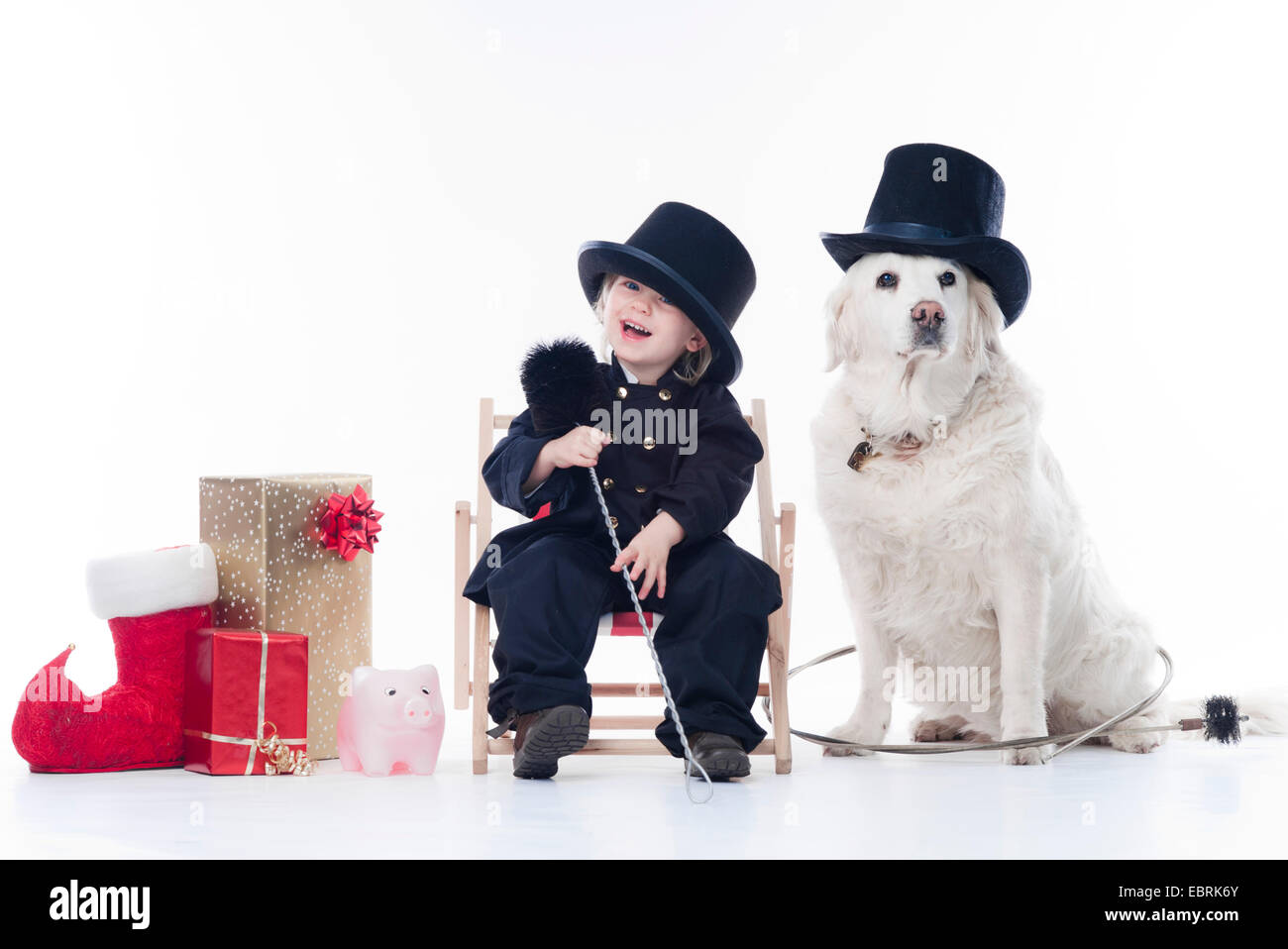 Golden Retriever (Canis lupus f. familiaris), little girl dressed as a ...