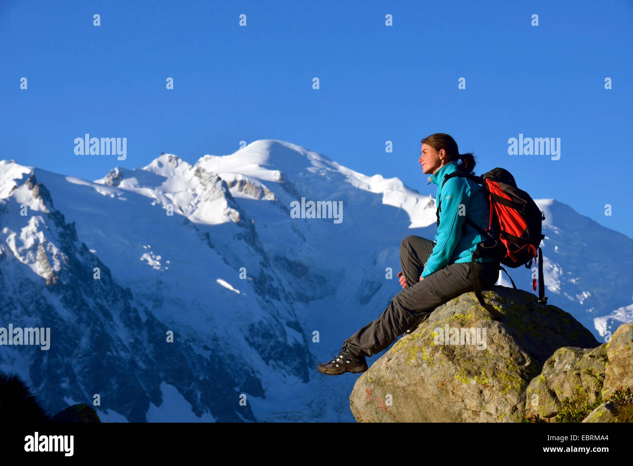 female mountain hiker sitting on Aiguilles Rouges in the opposite the ...