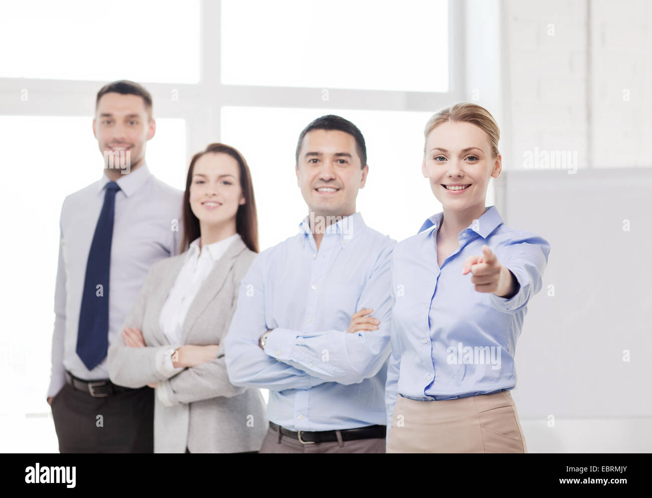 businesswoman in office pointing finger at you Stock Photo - Alamy