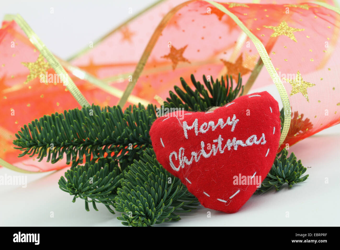 Merry Christmas heart with pine and ribbon Stock Photo - Alamy
