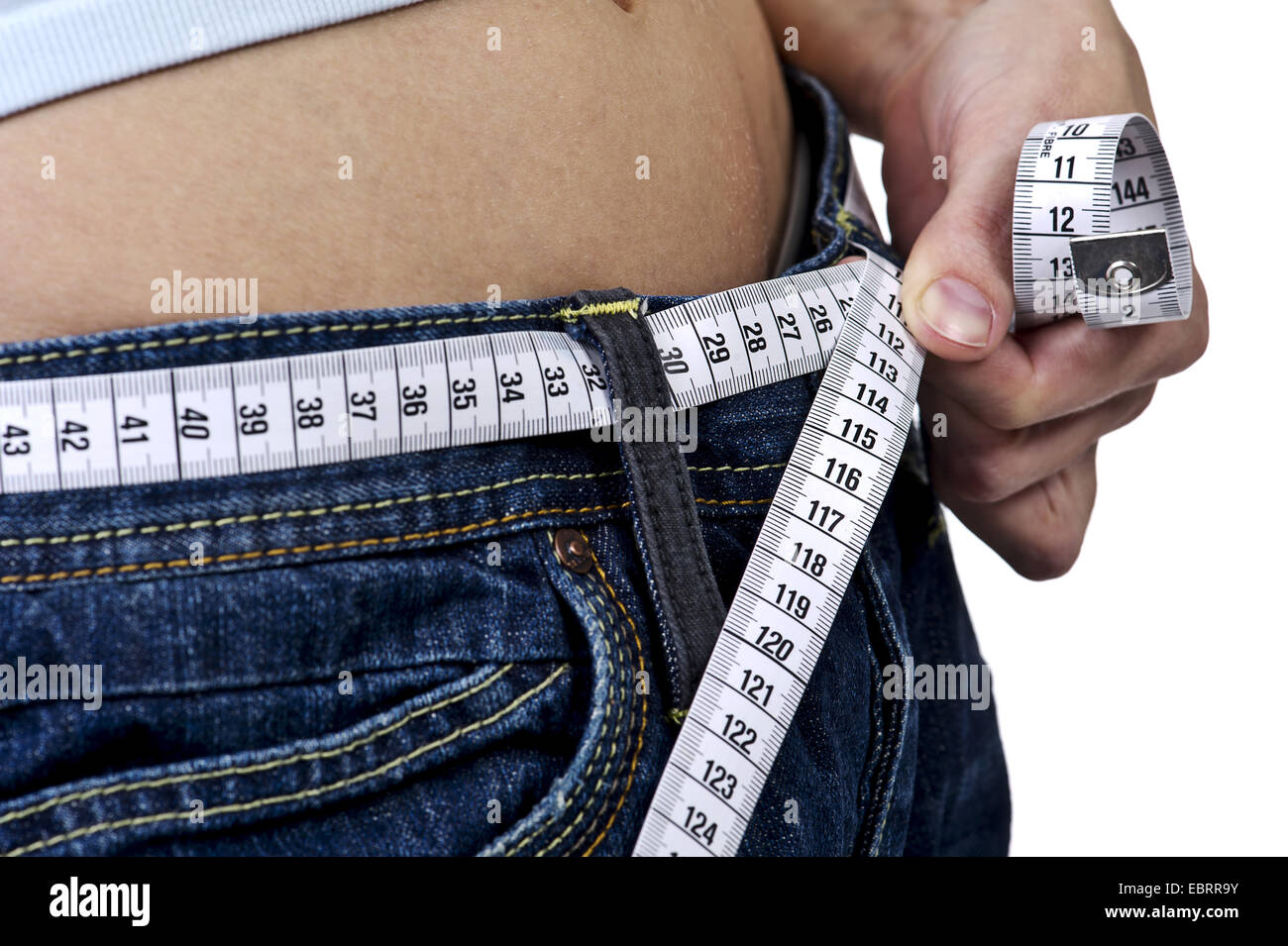 midsection of a young woman who has wrapped a measuring tape around her ...