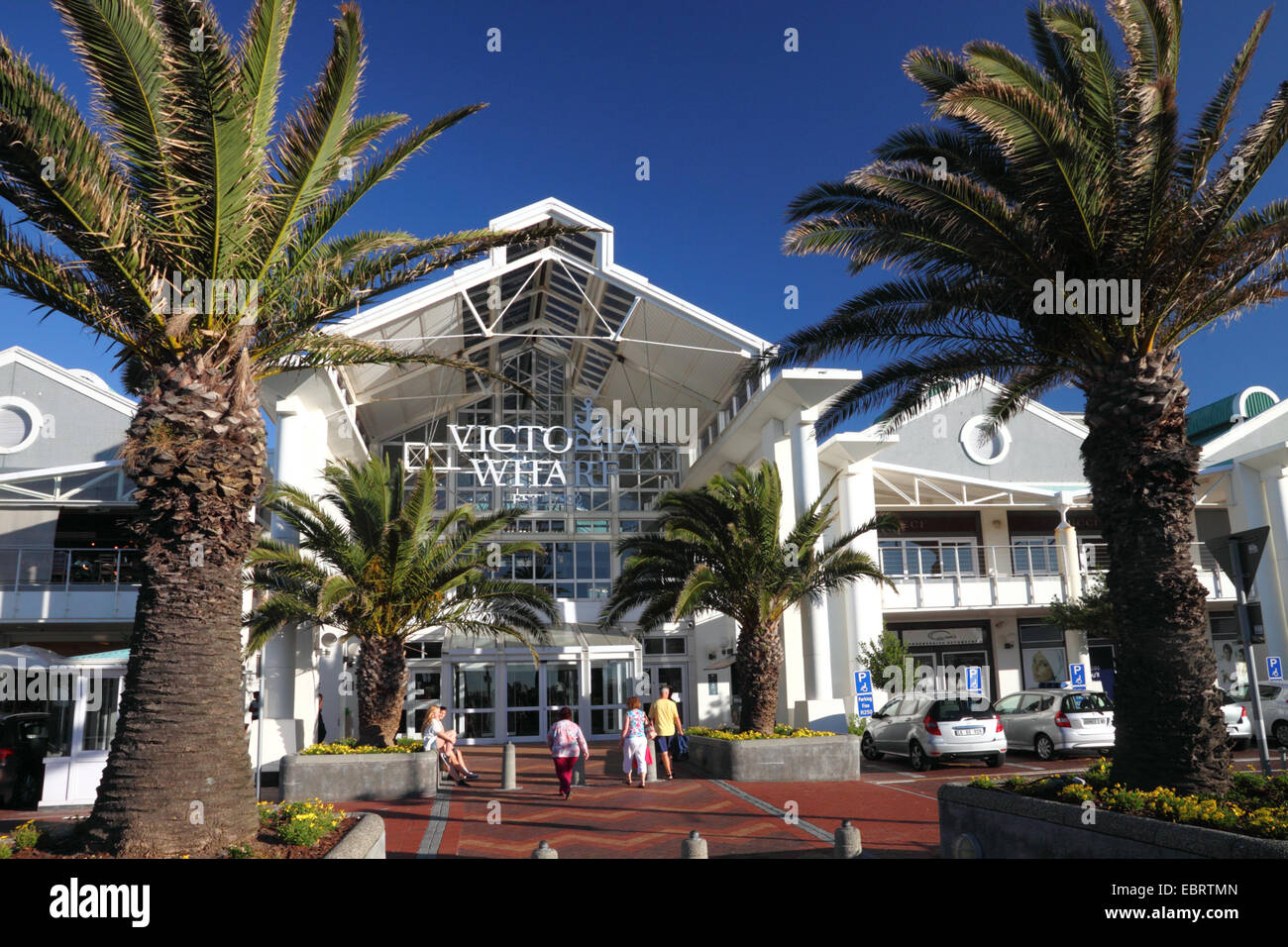 A modern shopping mall entrance framed by palm trees Stock Photo - Alamy