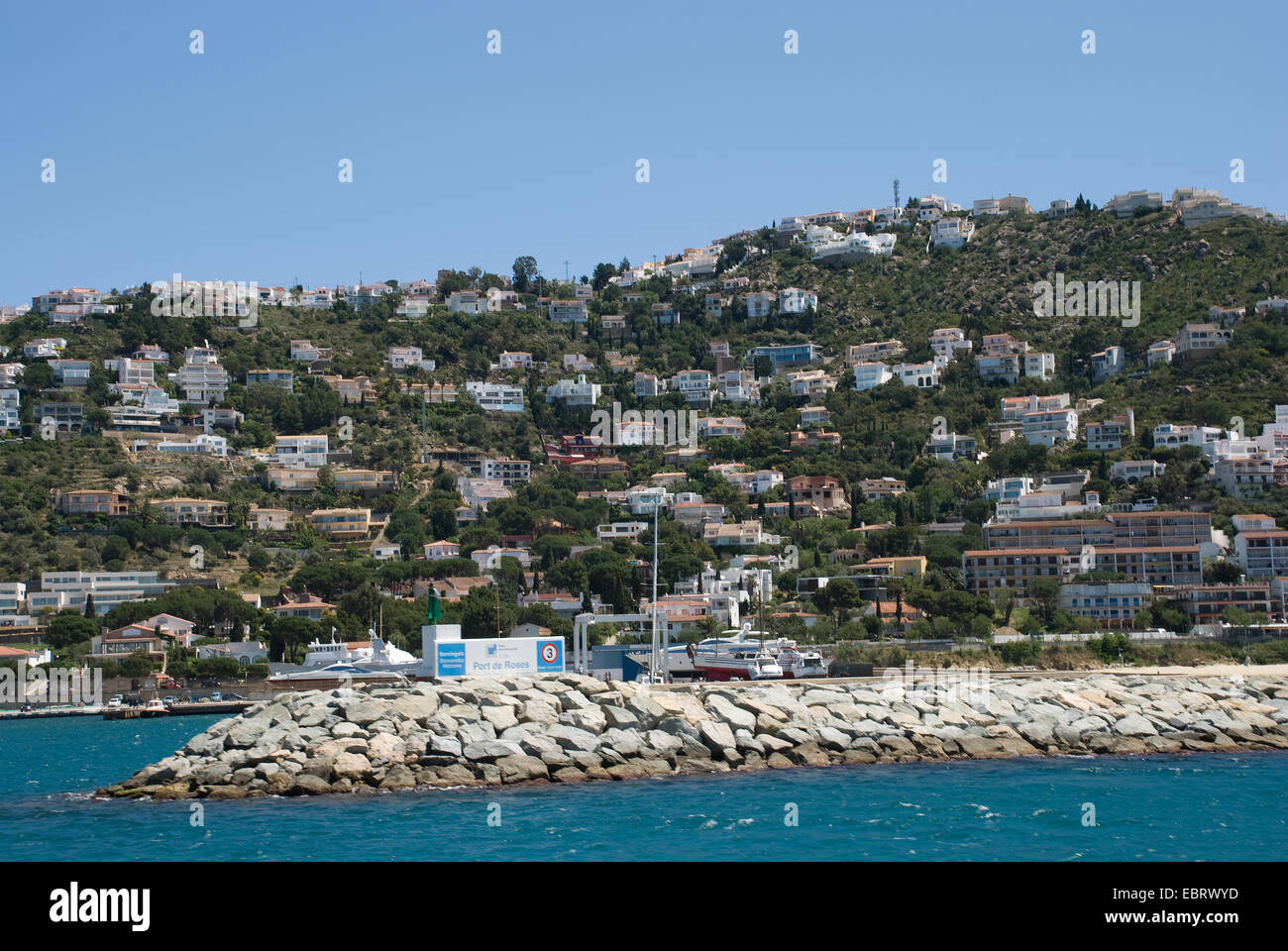 Port entrance at Roses along the Catalan coast of Spain against a ...