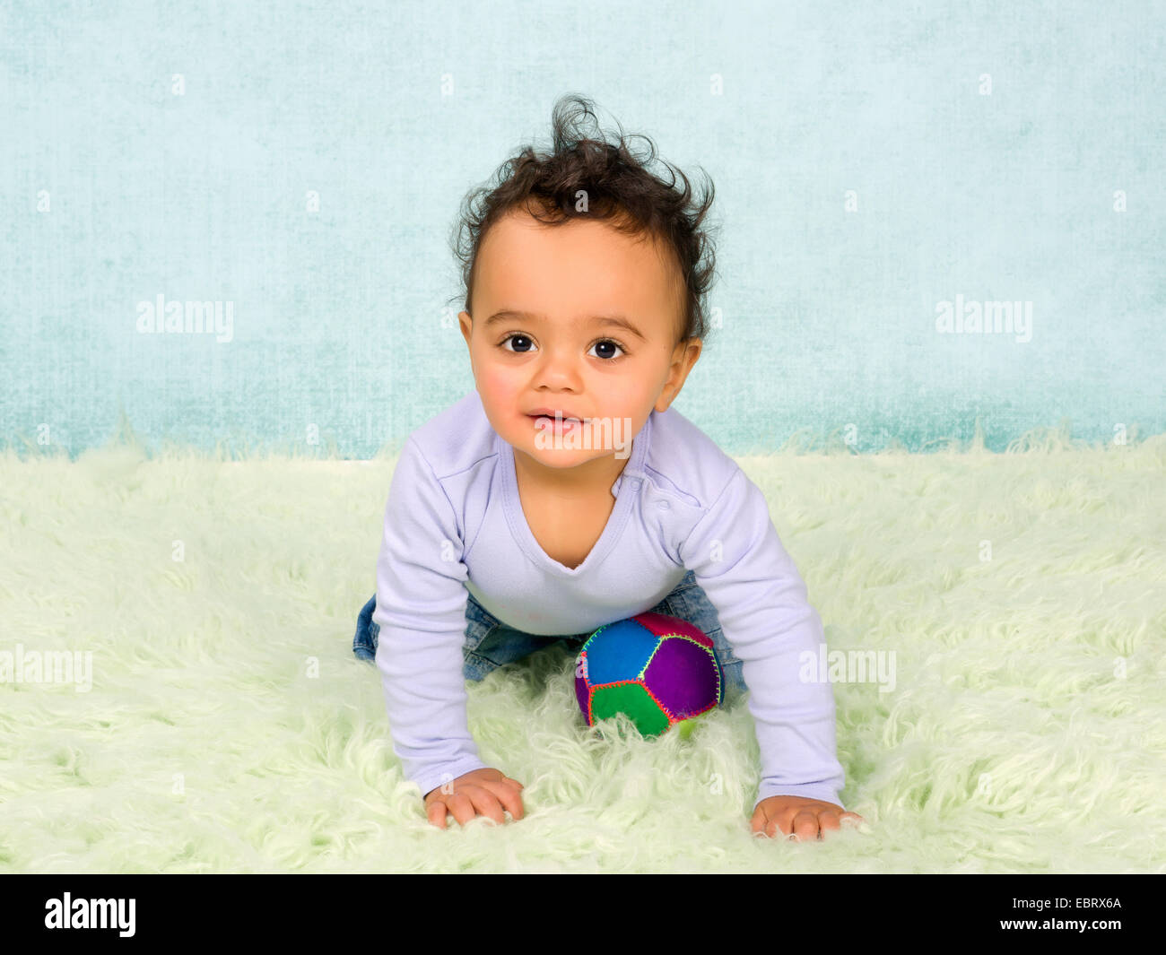 Cute African baby boy crawling in his little jeans Stock Photo - Alamy