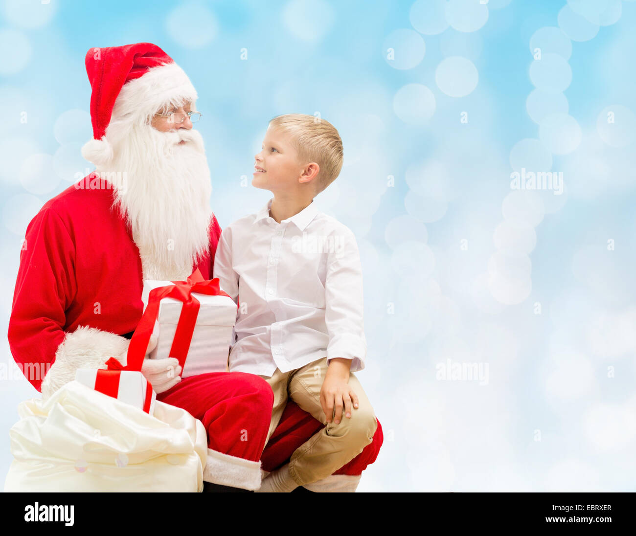 smiling little boy with santa claus and gifts Stock Photo - Alamy