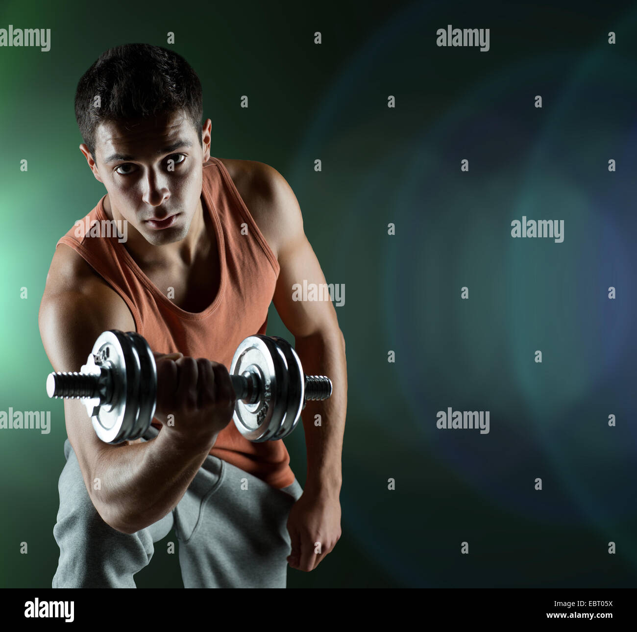 young man with dumbbell flexing biceps Stock Photo - Alamy