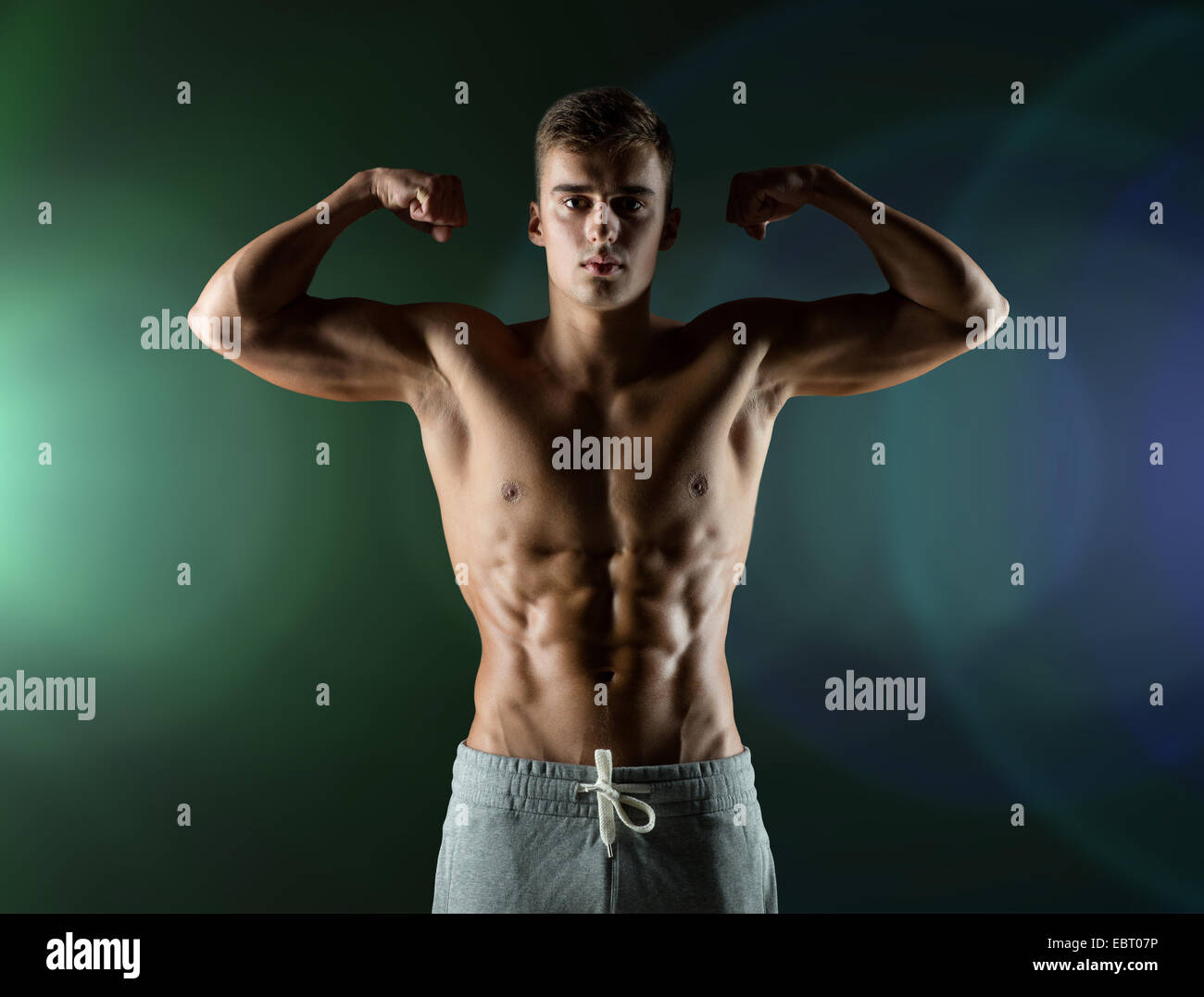 young man showing biceps and muscles Stock Photo - Alamy