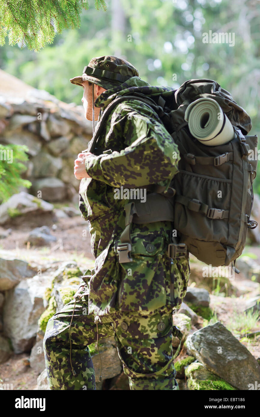 young soldier with backpack in forest Stock Photo - Alamy