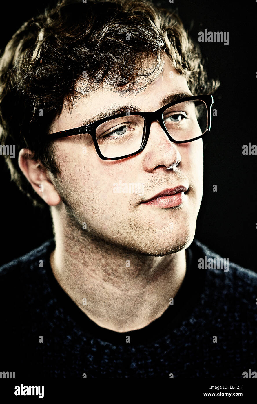 A photograph of a white European male age 19 shot in a studio against a ...