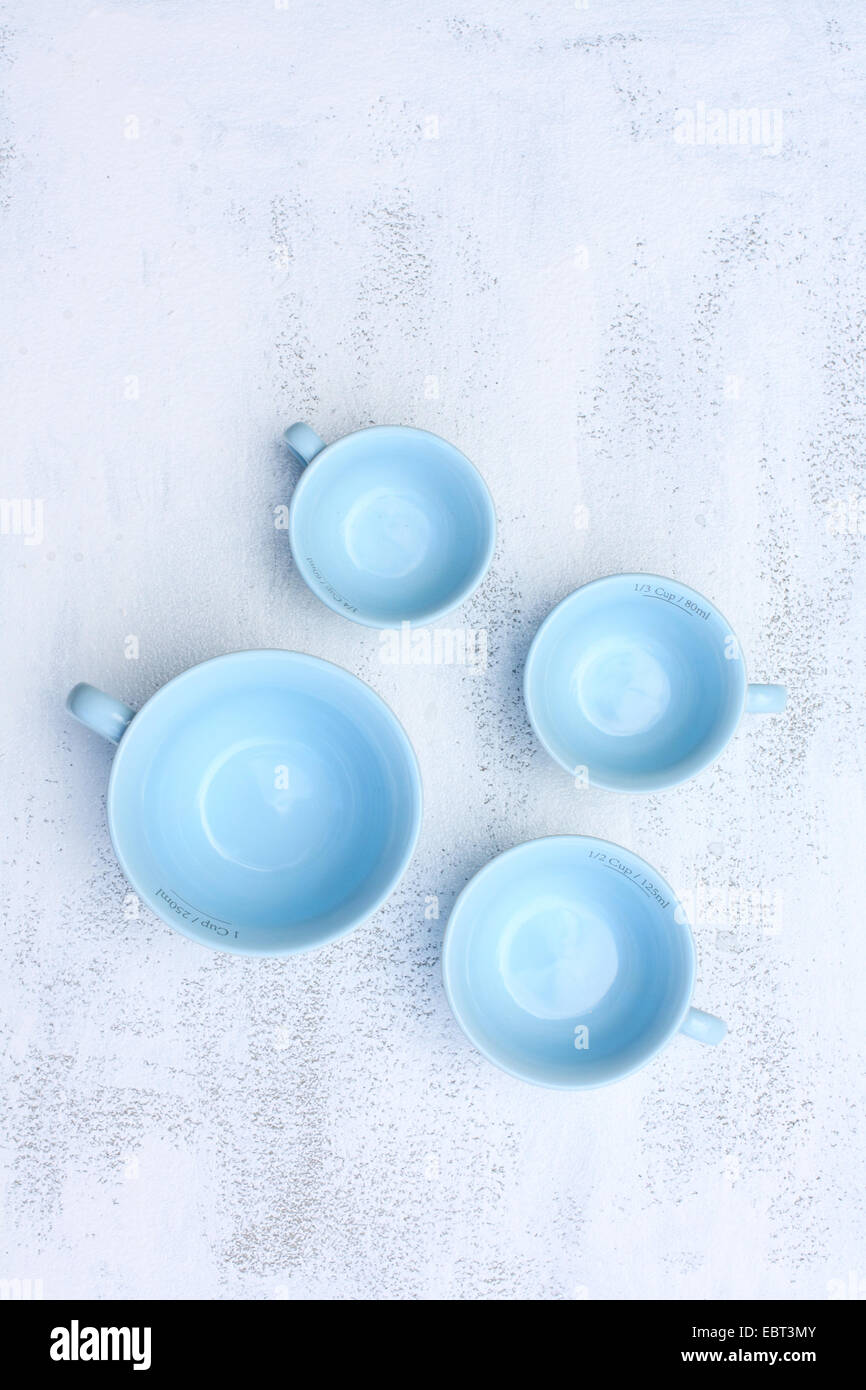 Four blue pastel teacups on white painted background Stock Photo - Alamy