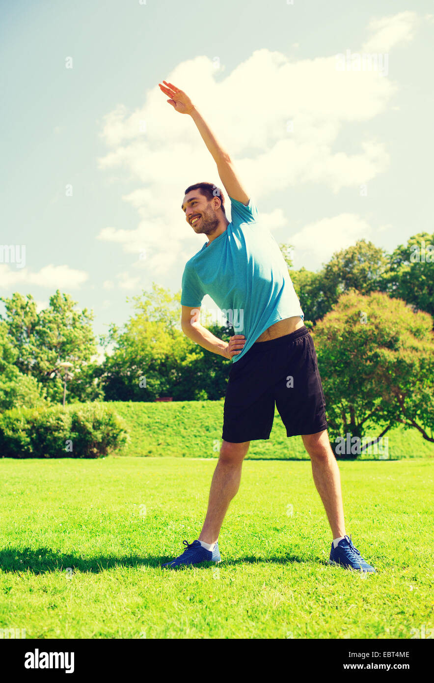 smiling man stretching outdoors Stock Photo - Alamy