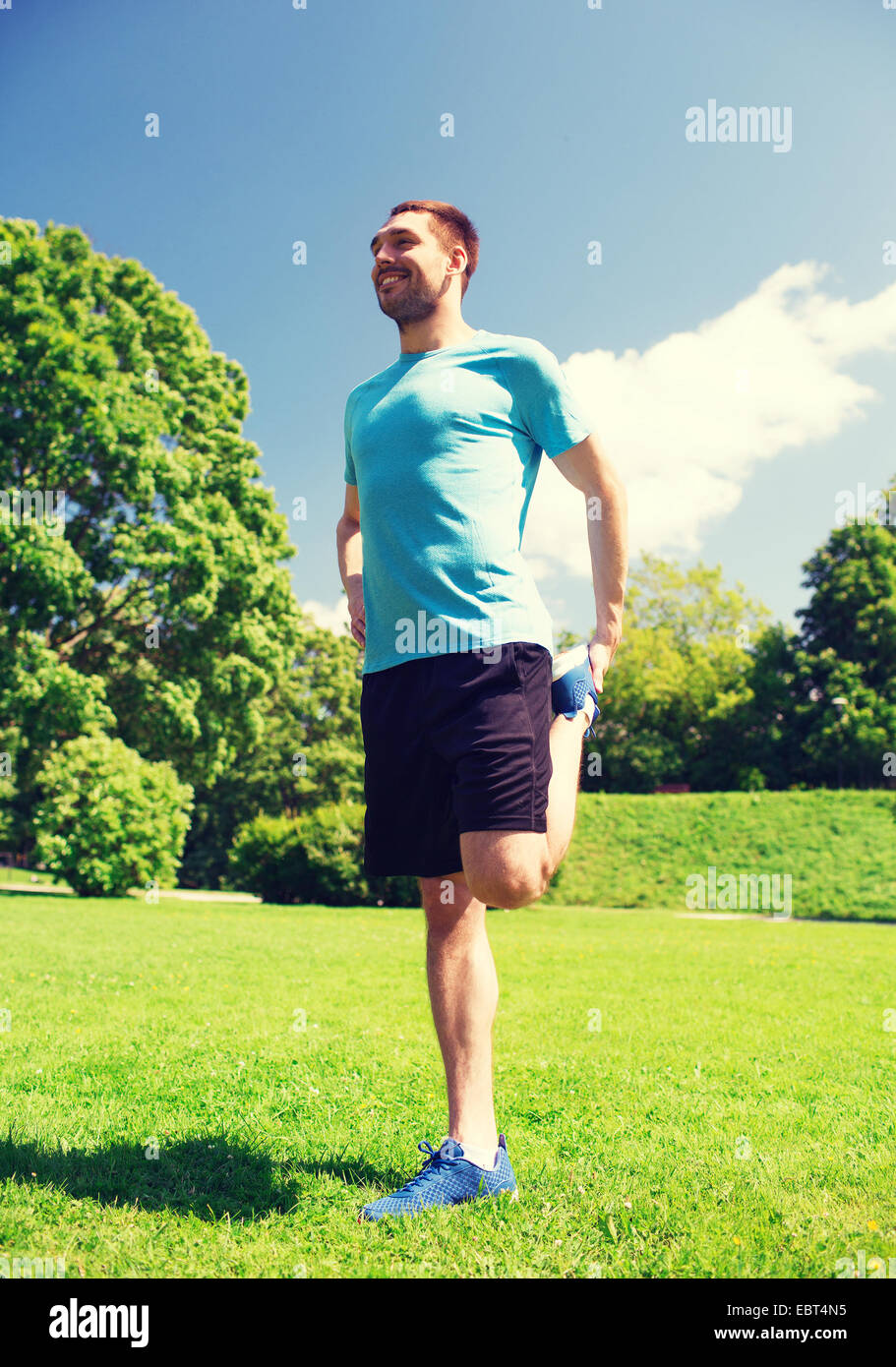 smiling man stretching outdoors Stock Photo - Alamy