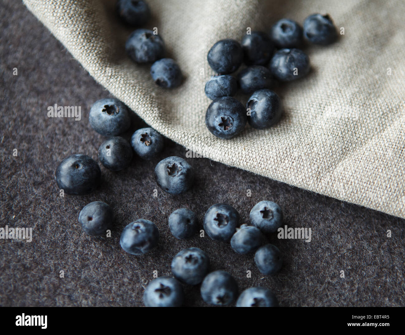 Blueberries, grey felt and linen as background Stock Photo - Alamy