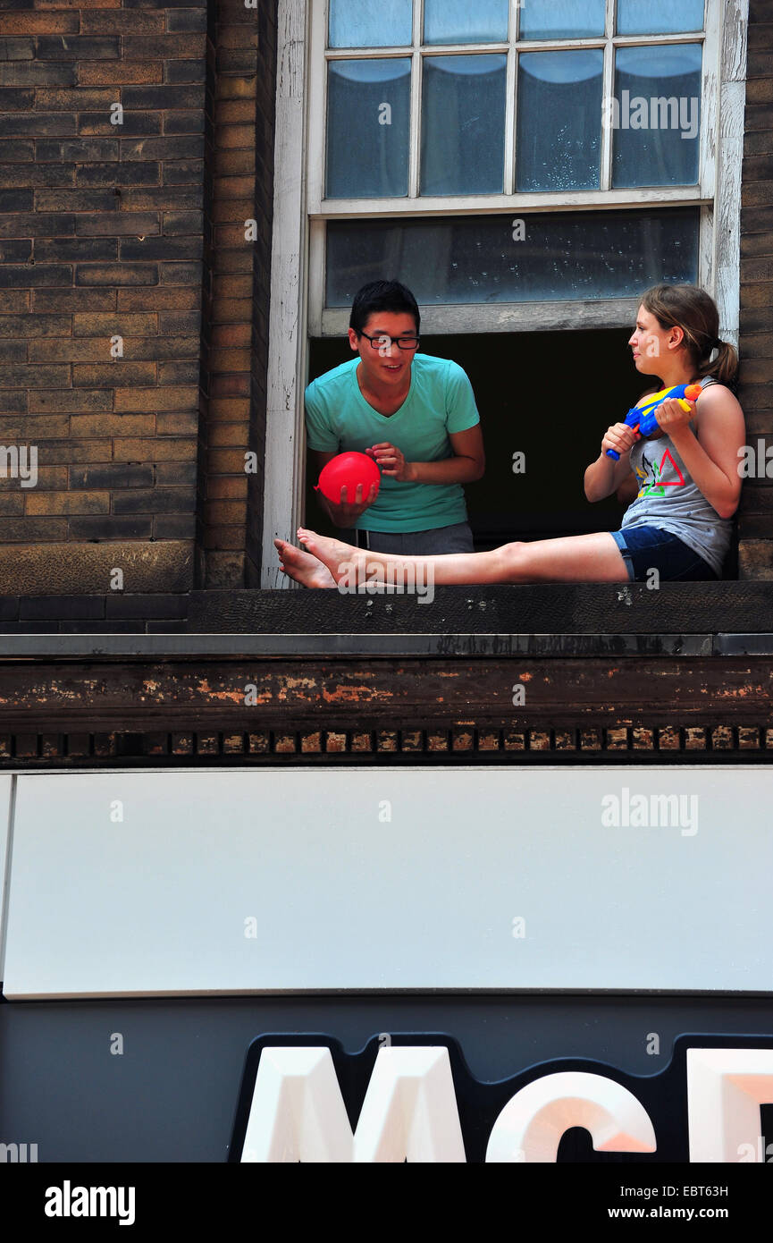 People leaning out of a window at the 2014 World Pride in Toronto Stock ...