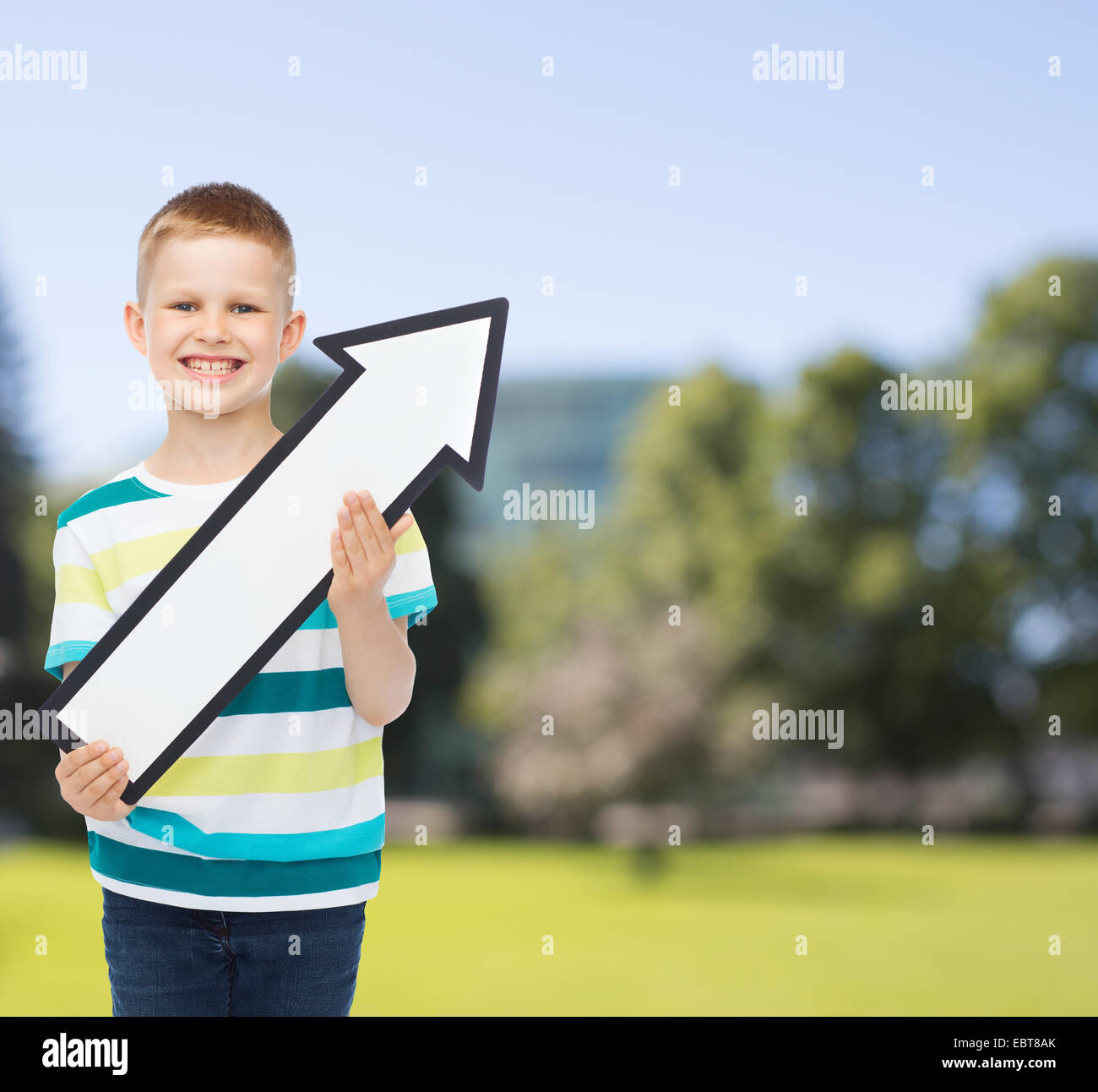 smiling little boy with blank arrow pointing right Stock Photo - Alamy