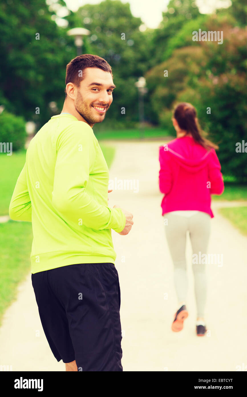 Woman running looking back hi-res stock photography and images - Alamy