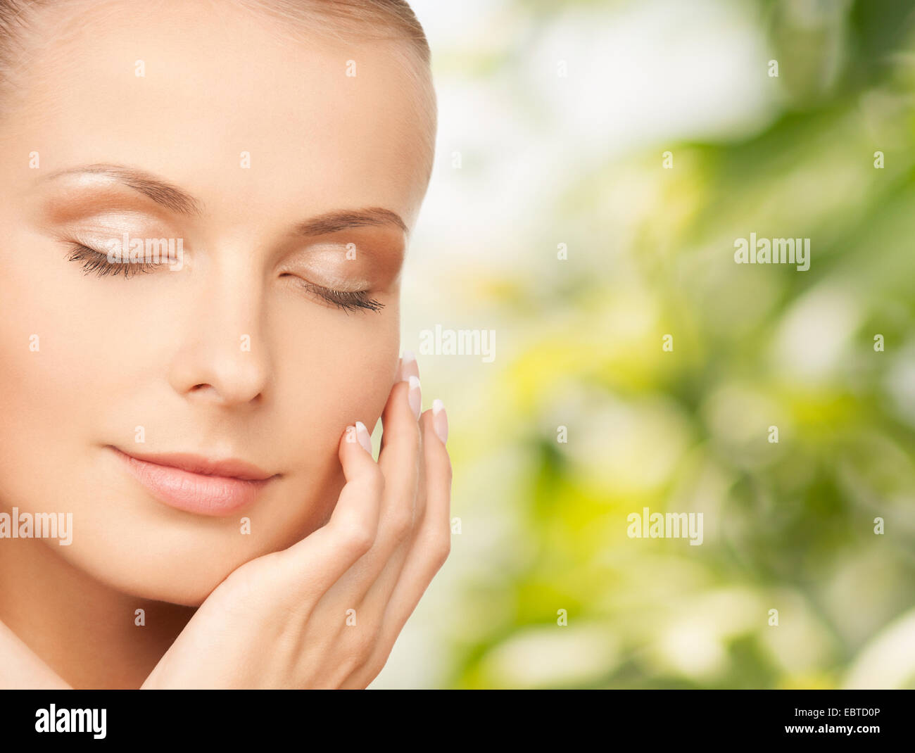 beautiful young woman touching her face Stock Photo - Alamy