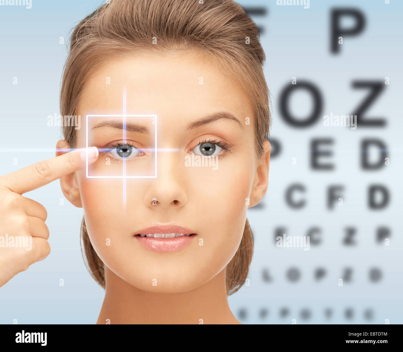 beautiful young woman pointing finger to her eye Stock Photo - Alamy