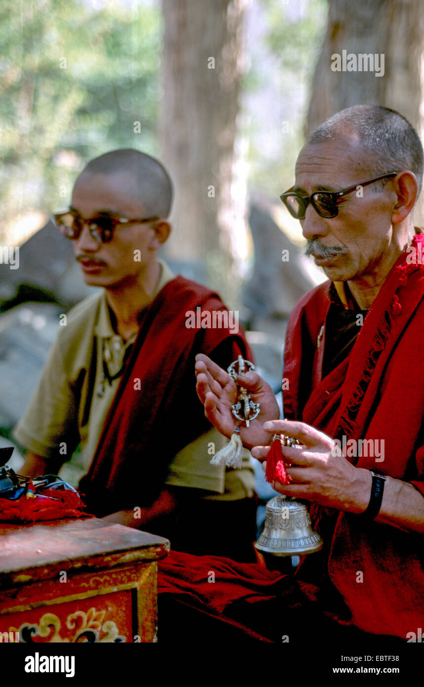 Ladakh Tibet 2 men monks bell dorje sunglasses sun light meditating sat ...