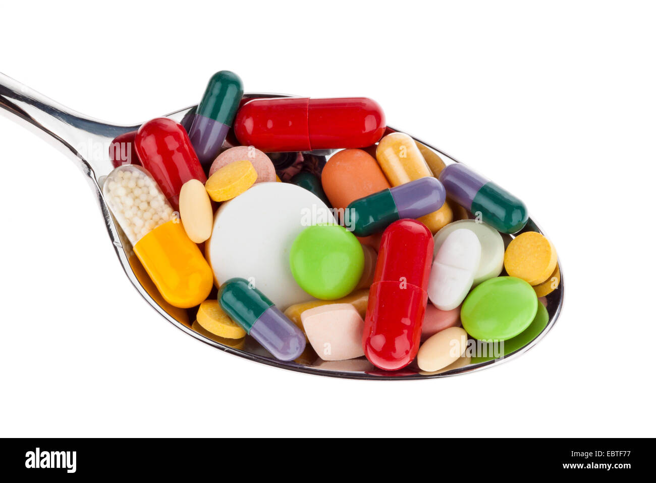 Many different colored tablets on a spoon. Abuse of drugs Stock Photo ...