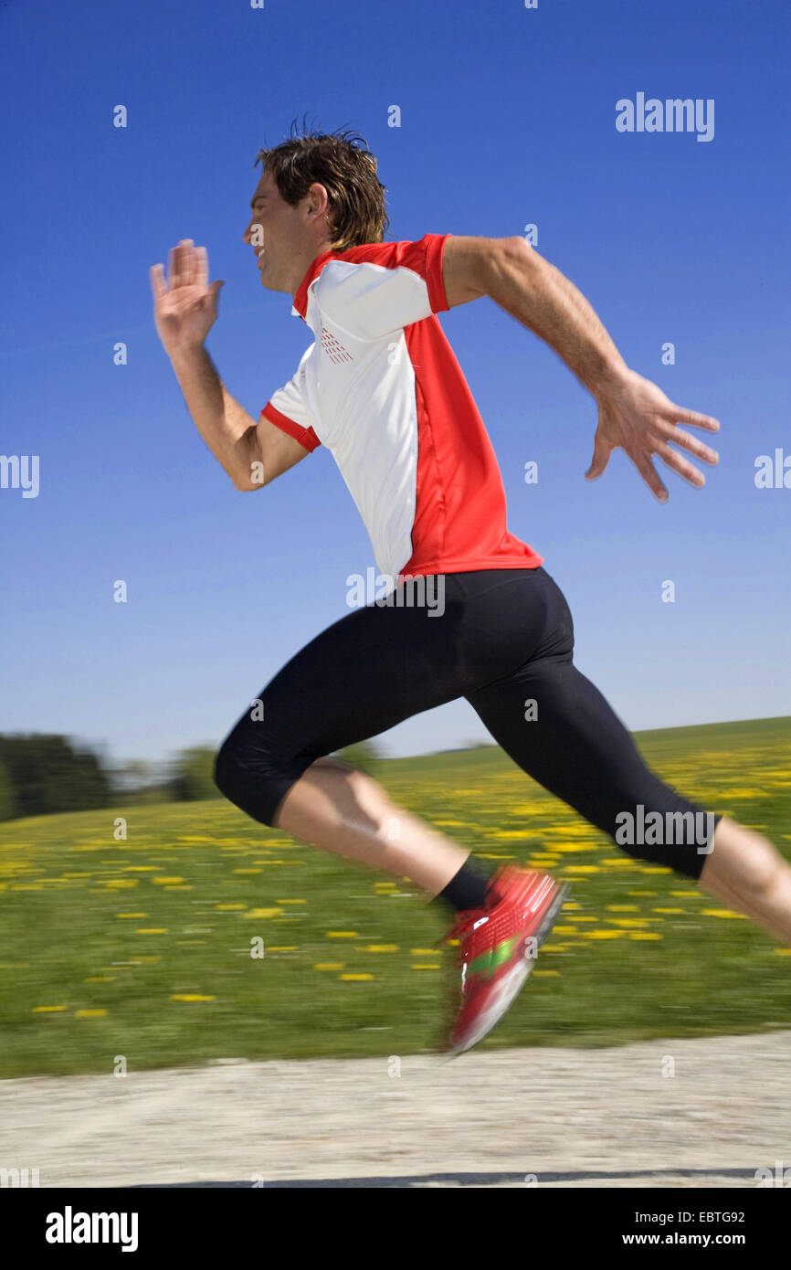 man running running on a gravel road, Italy Stock Photo - Alamy