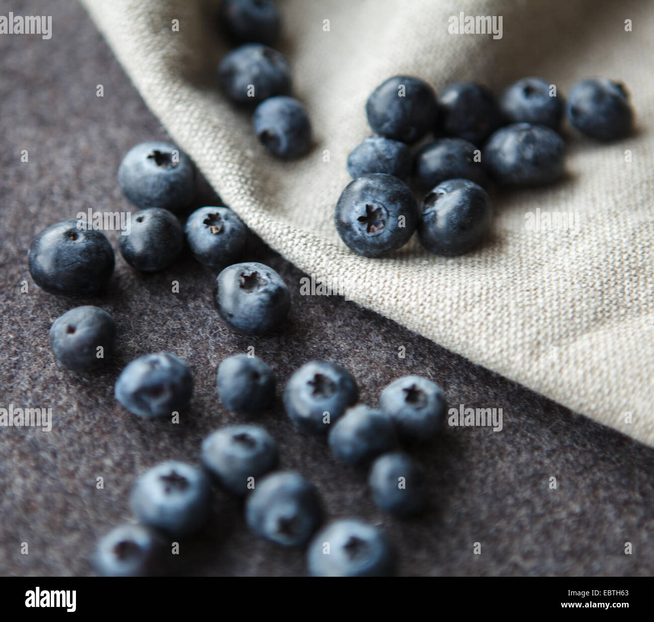 Blueberries, grey felt and linen as background Stock Photo - Alamy