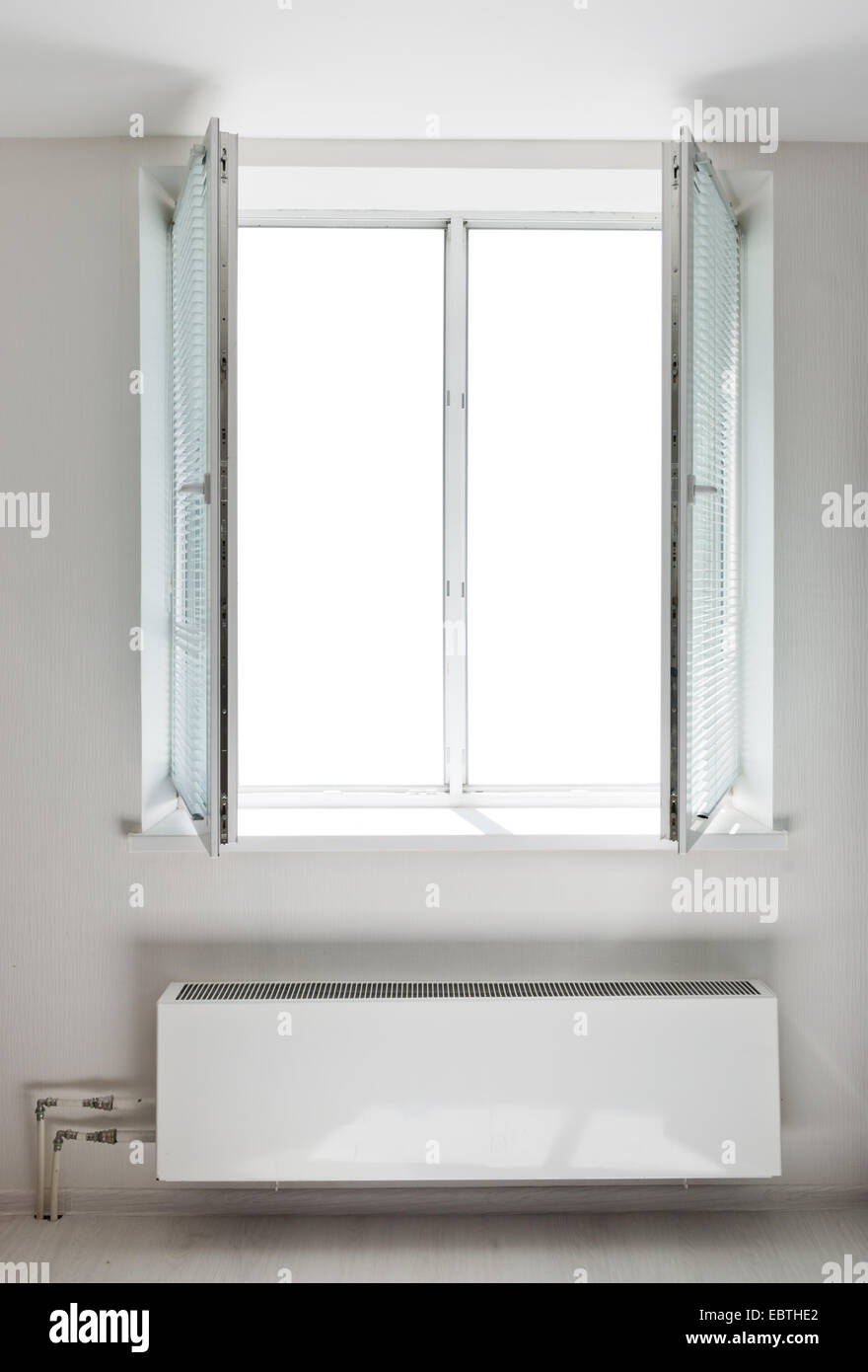 White plastic double door window with radiator under it. Domestic room ...