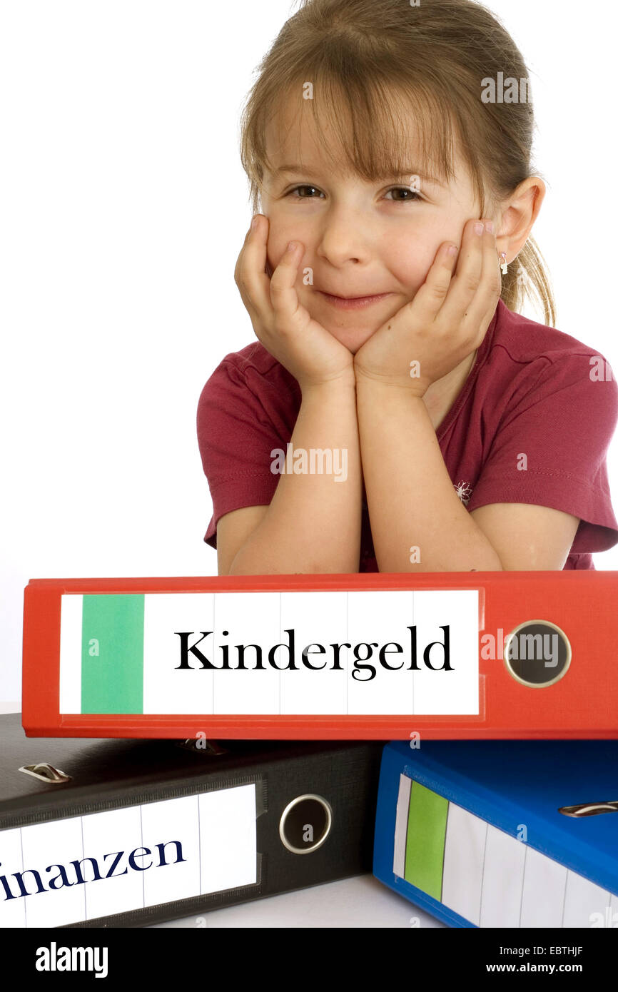 little girl smiling while leaning on a file with the inscription ...