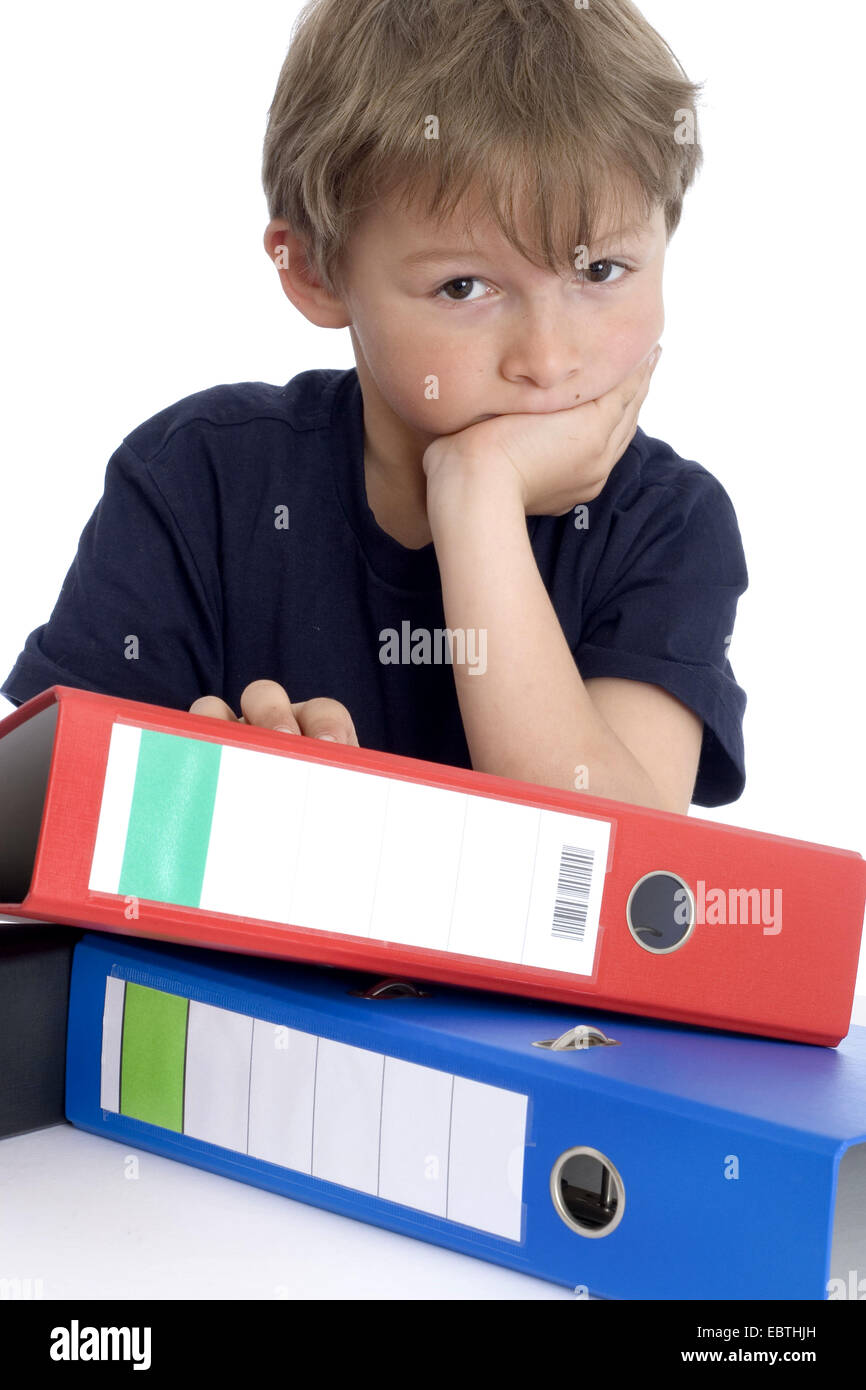 little boy leaning on a stack of files with a smile Stock Photo - Alamy