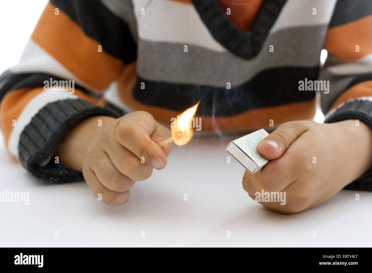 hands of a little boy having lighted a matchstick Stock Photo - Alamy