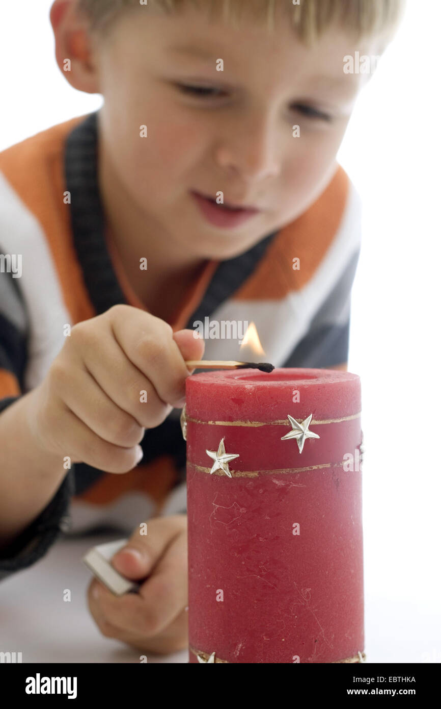 little boy lighting a candle with a matchstick Stock Photo - Alamy