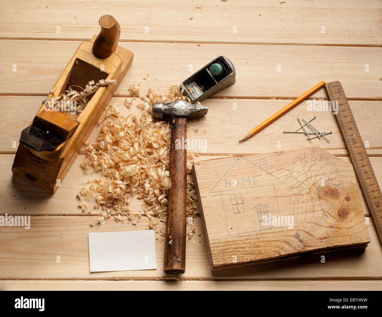 carpenter tools,hammer,meter, nails,shavings, and chisel over wood ...
