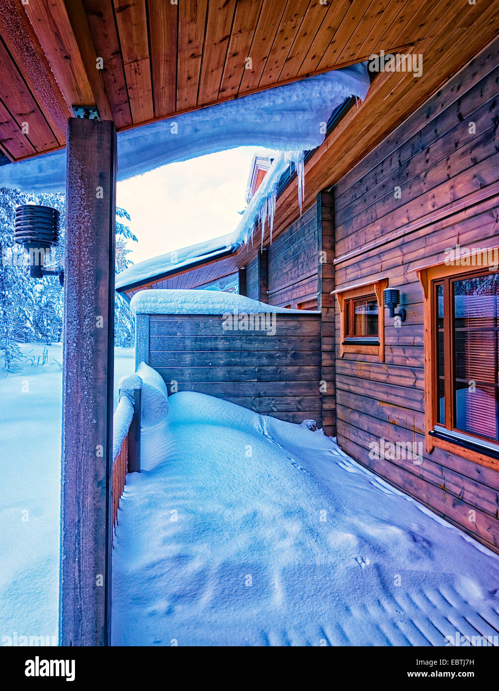 Terrace under snow in forest cottage Stock Photo - Alamy