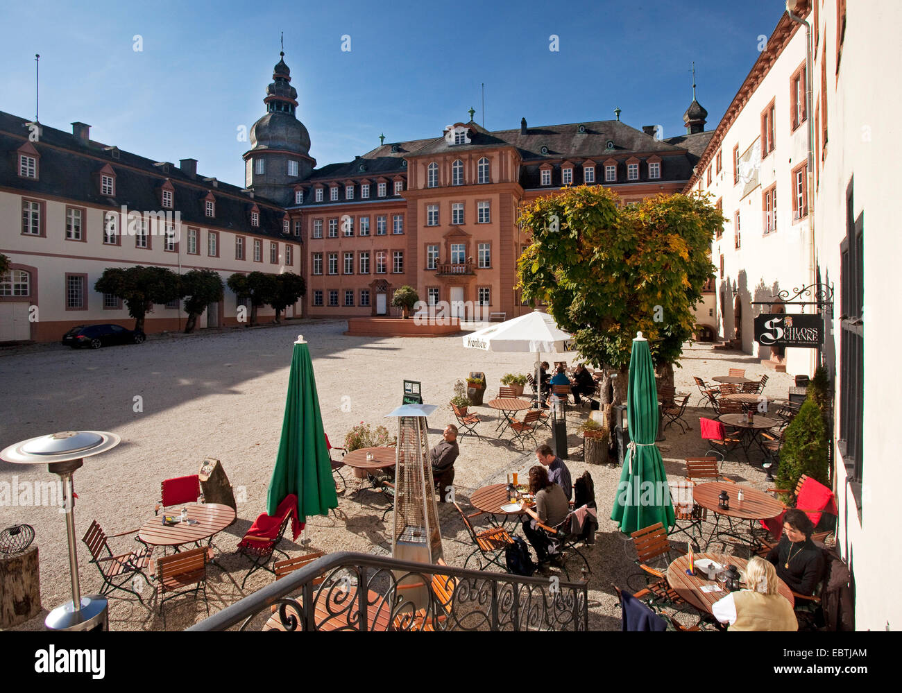 persons in a cafe in the yard of Berleburg castle, Germany, North Rhine ...