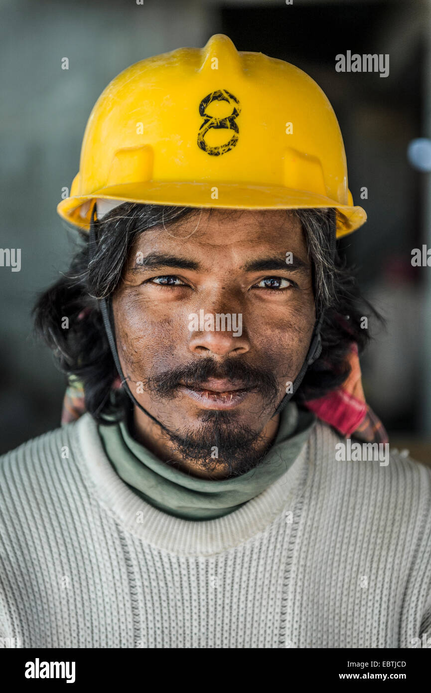 Migrant Indian workers with safety helmet in Thimphu Stock Photo - Alamy