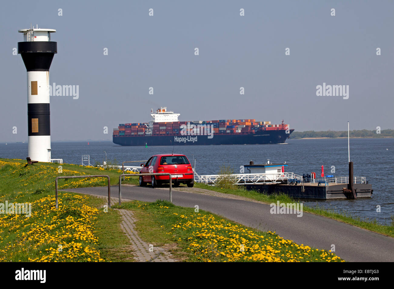 navigational light Twielenfleth, cargo ship in background, Germany ...