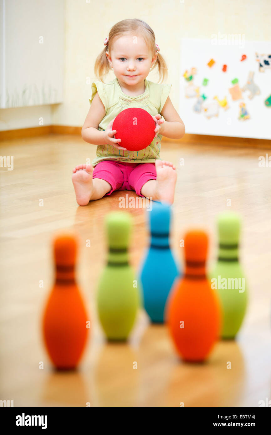 little girl bowling in the nursery Stock Photo - Alamy