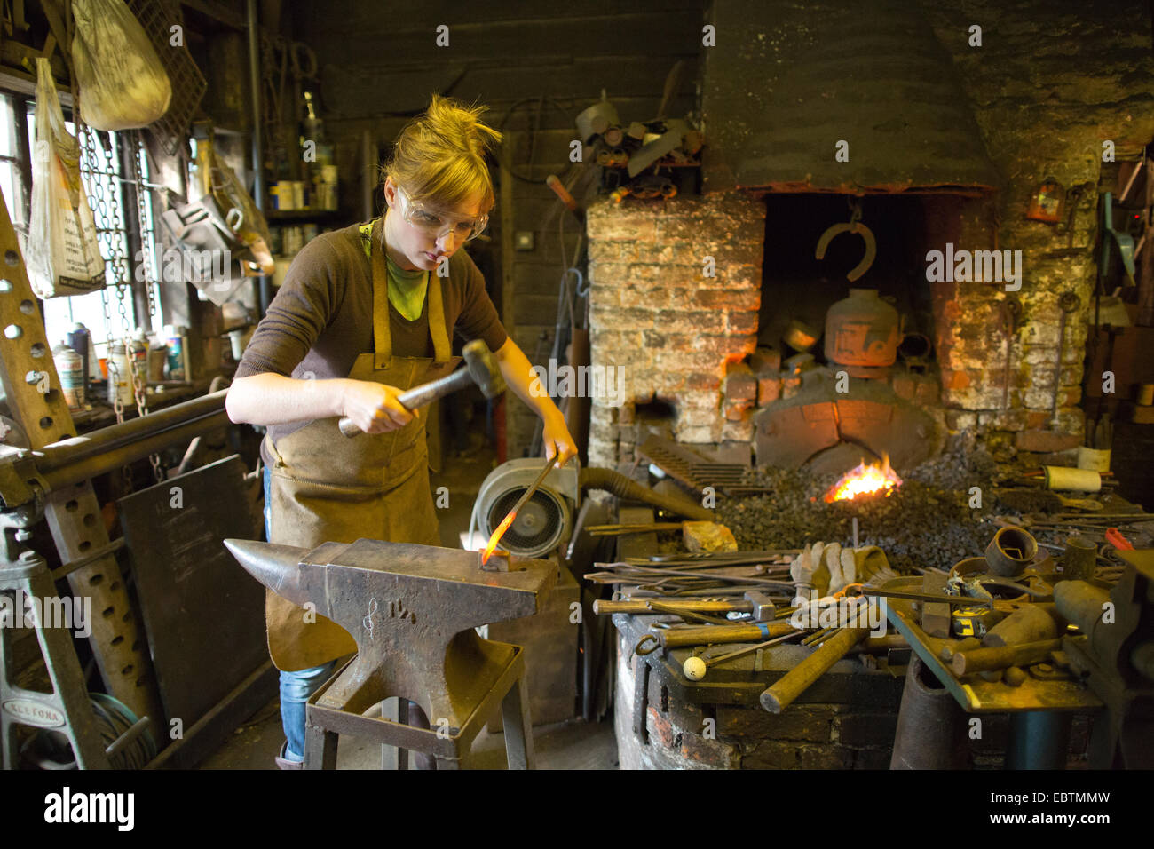 Woman blacksmith working in forge hi-res stock photography and images ...