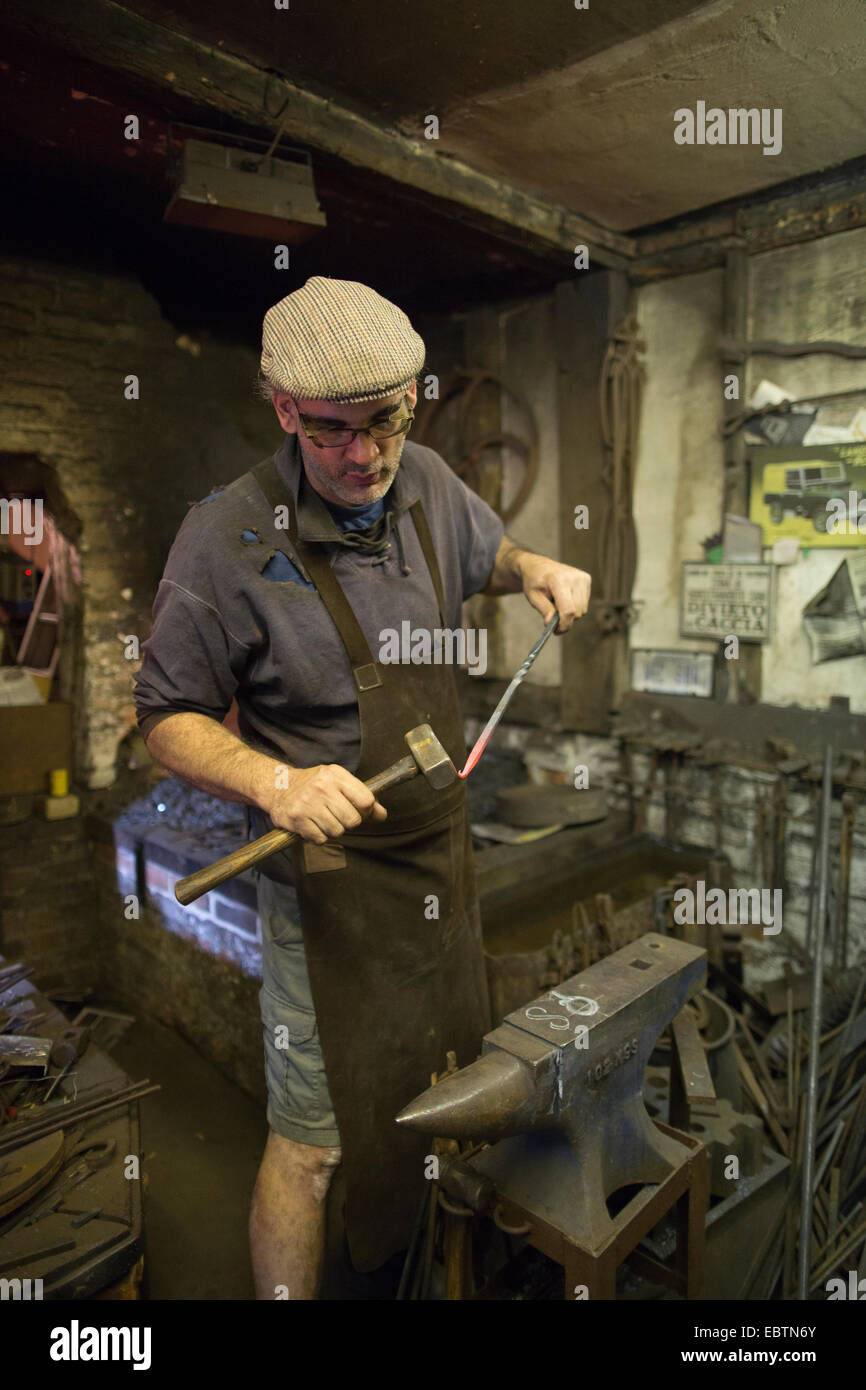 Blacksmith working in a forge, Much Hadham, Herfordshire, England, UK ...
