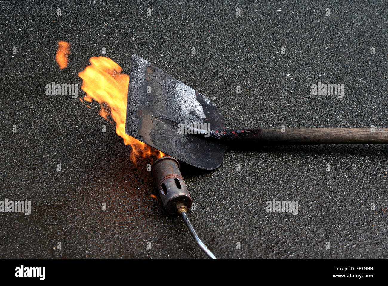 heating a bucket to work with bitumen, Germany, North Rhine-Westphalia ...