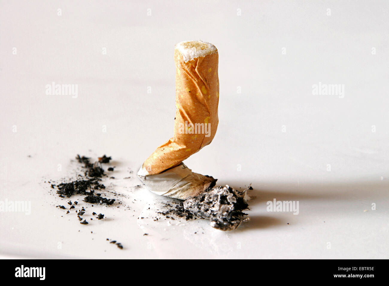 cigarette stubbed out on a white surface Stock Photo - Alamy