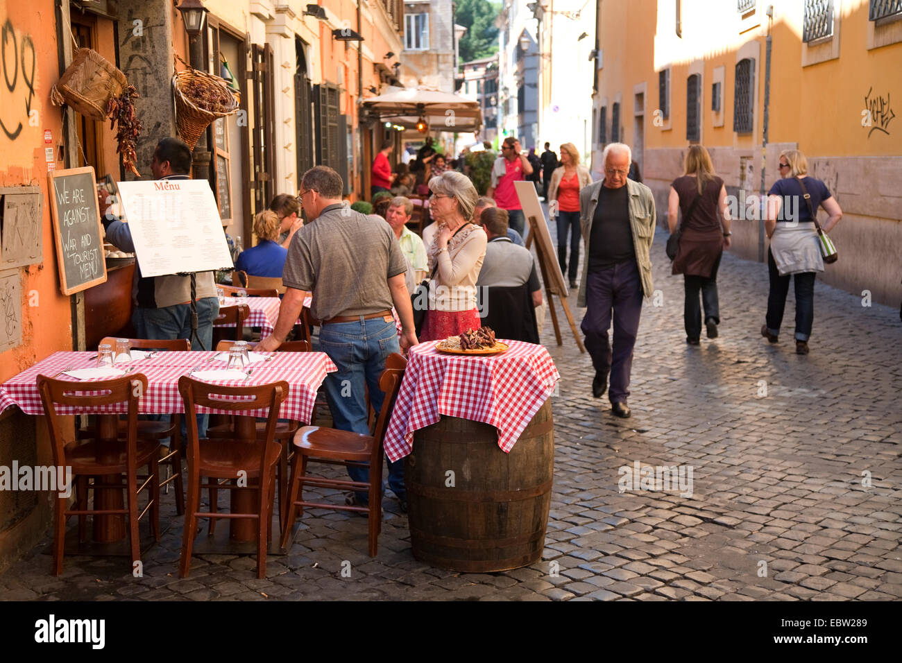 tourists looking at menue card of a trattoria, street scenery, Italy ...