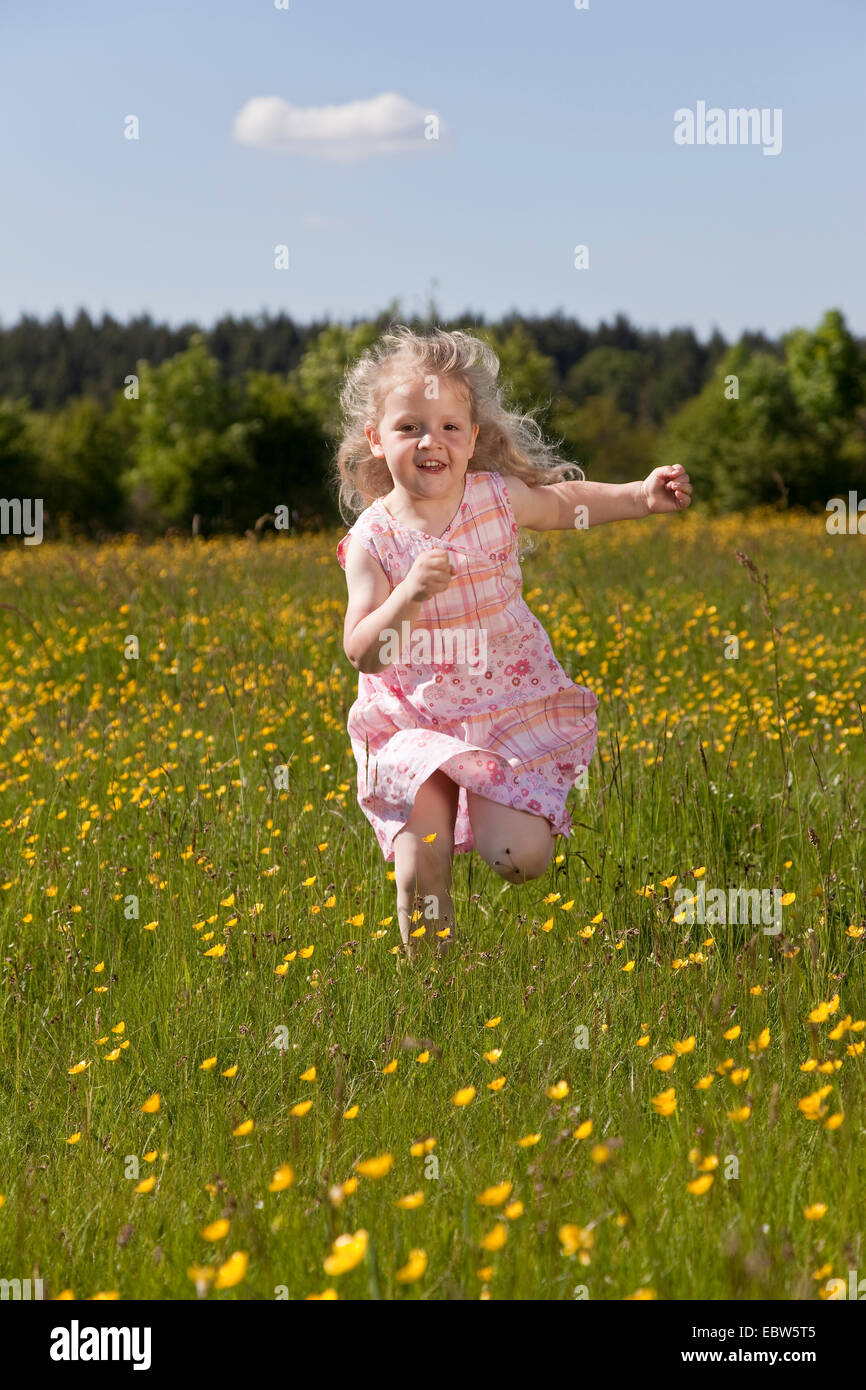 happy little girl running across a meadow, Germany Stock Photo - Alamy