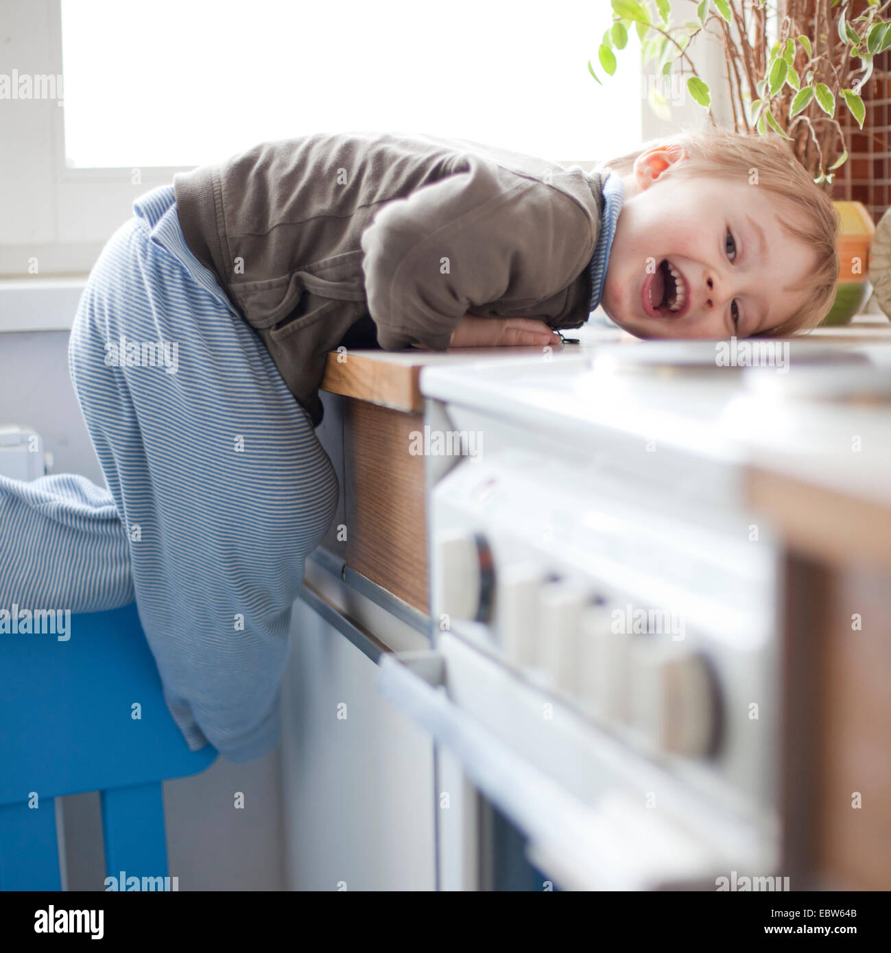 Toddler climbing kitchen counter hi-res stock photography and images ...