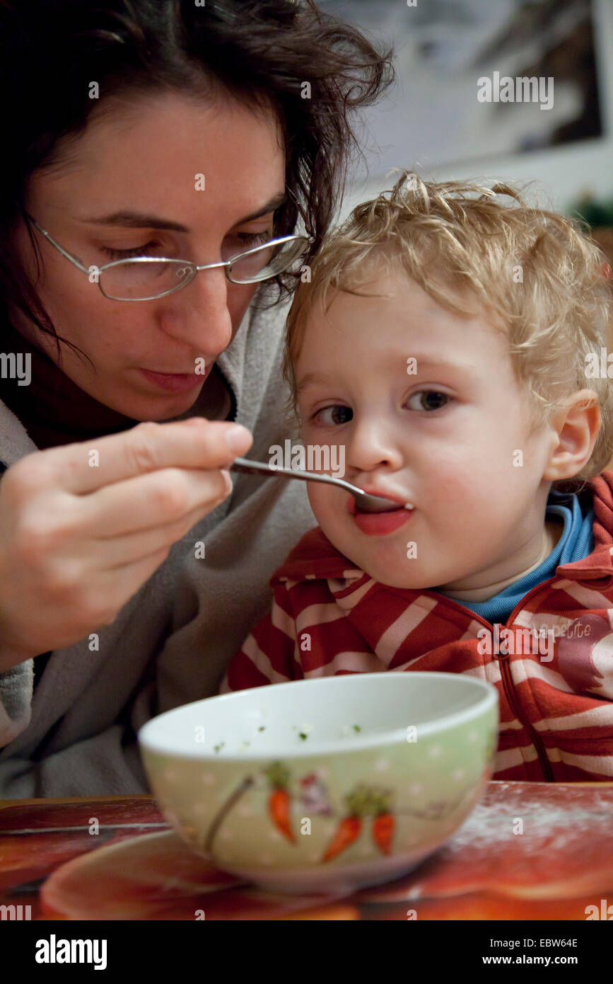 mother feeding her little boy Stock Photo - Alamy