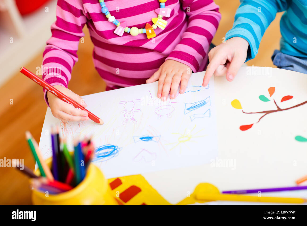 two little children drawing with crayons Stock Photo - Alamy