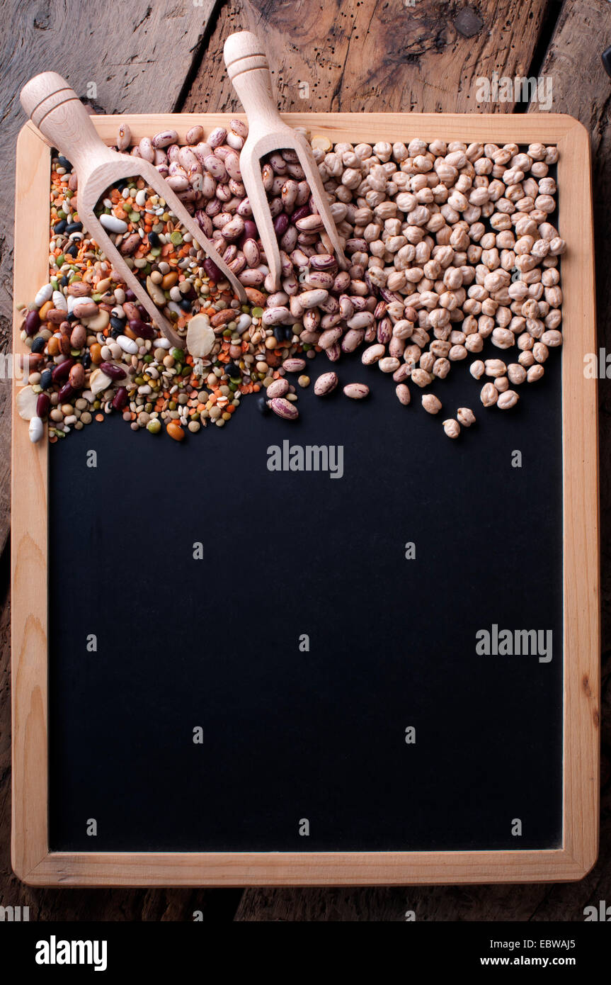 mixed pulses on a blackboard with two spoons Stock Photo - Alamy