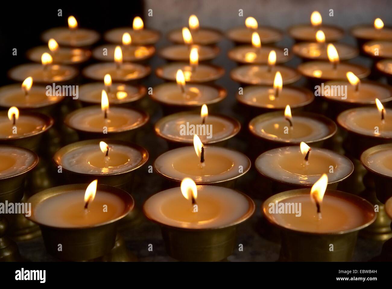 Rows of candles in the indian temple Stock Photo - Alamy