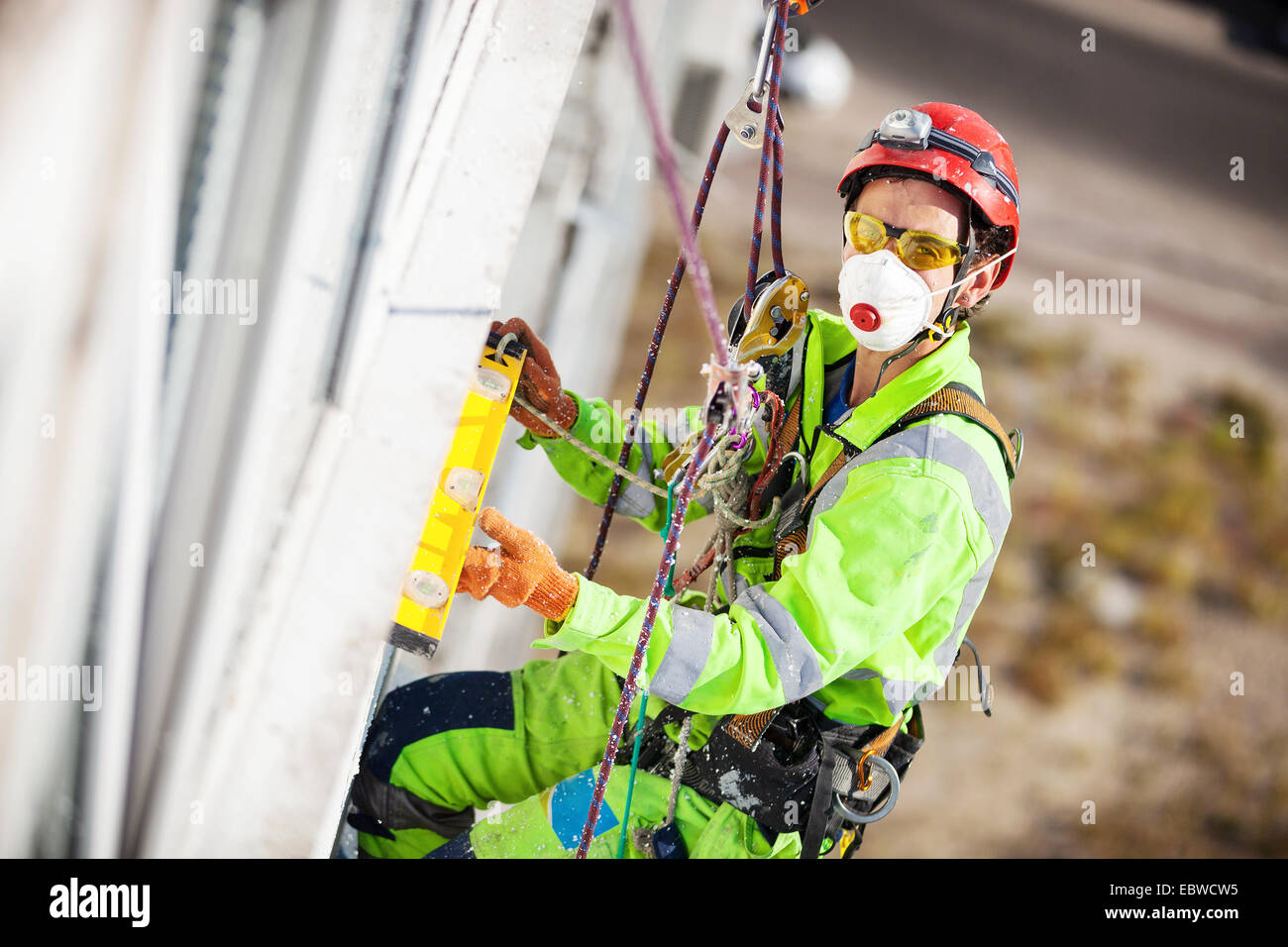 Industrial climber measuring with level tube during construction Stock ...