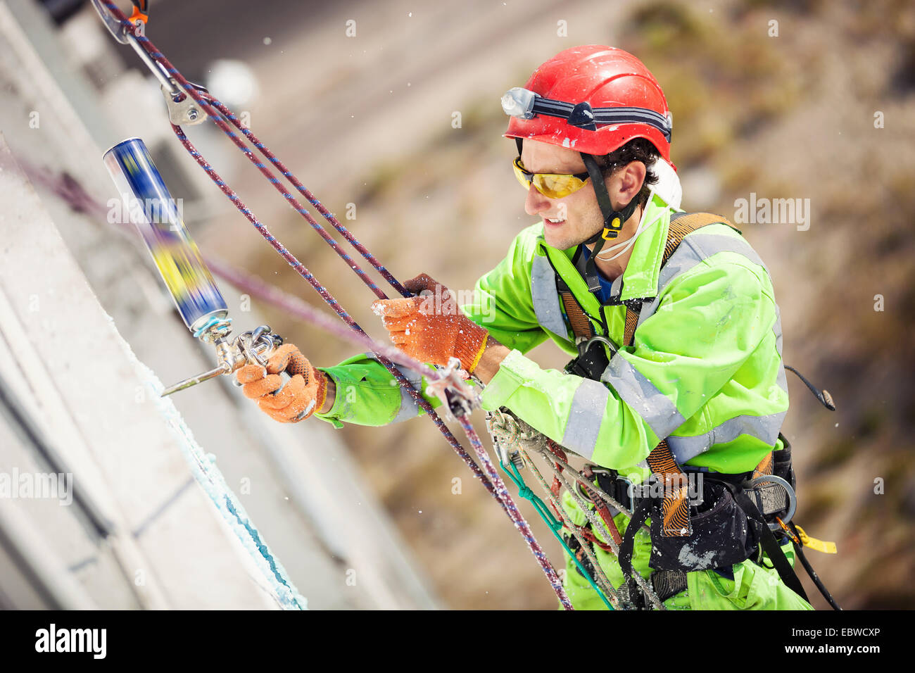 Industrial climber on a building during winterization works Stock Photo ...
